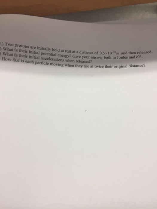 Solved ) Two protons are initially held at rest at a | Chegg.com