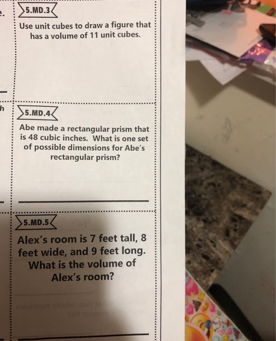 Solved 5.MD.3 Use unit cubes to draw a figure that has a | Chegg.com