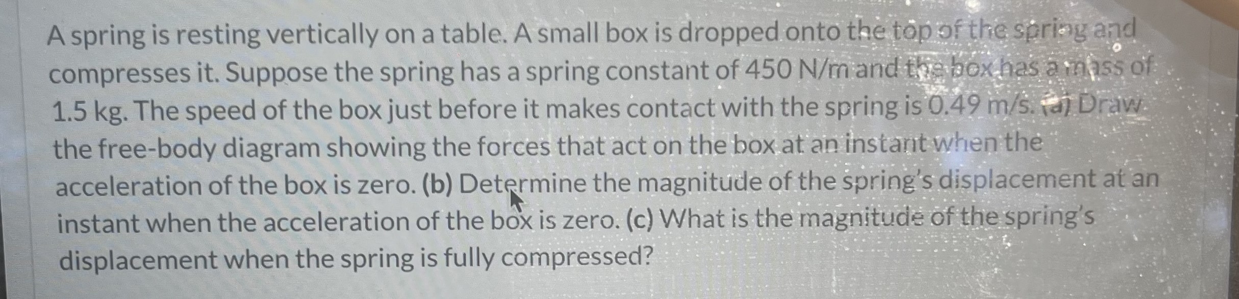Solved A spring is resting vertically on a table. A small | Chegg.com