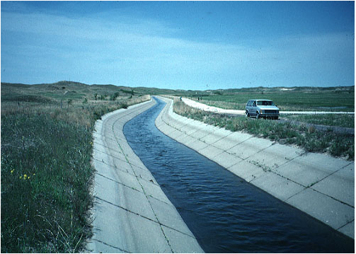 Solved A concrete-lined irrigation canal brings water from | Chegg.com