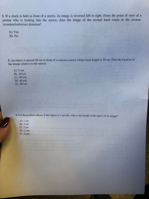 Solved 2. If a clock is held in front of a mirror, its image | Chegg.com