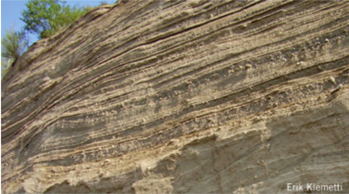Solved This photo shows layers of volcanic material ejected | Chegg.com