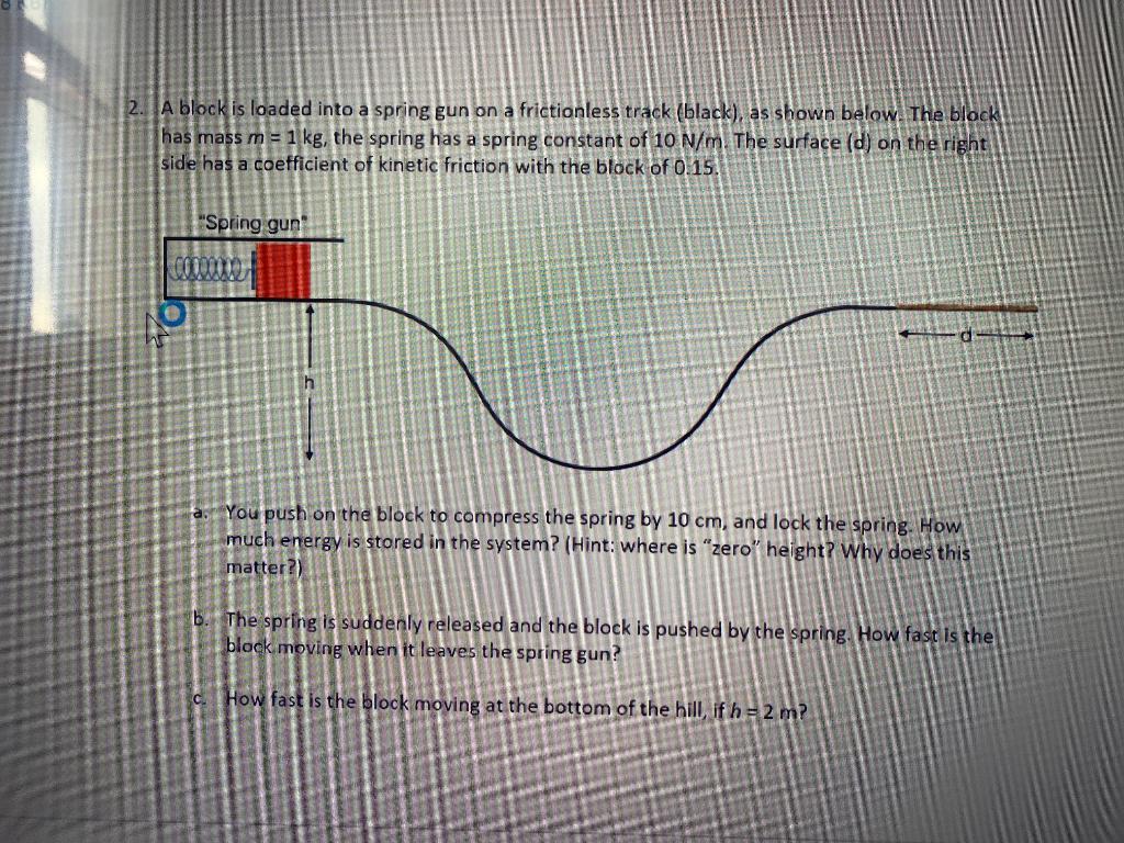 Solved 2. A block is loaded into a spring gun on a | Chegg.com