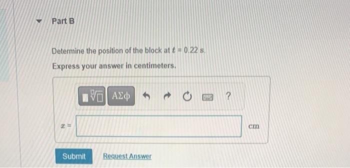 Solved A block on a low friction table is attached to a | Chegg.com