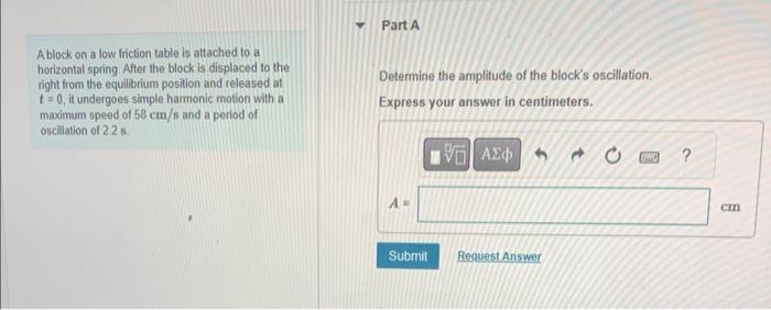 Solved A block on a low friction table is attached to a | Chegg.com