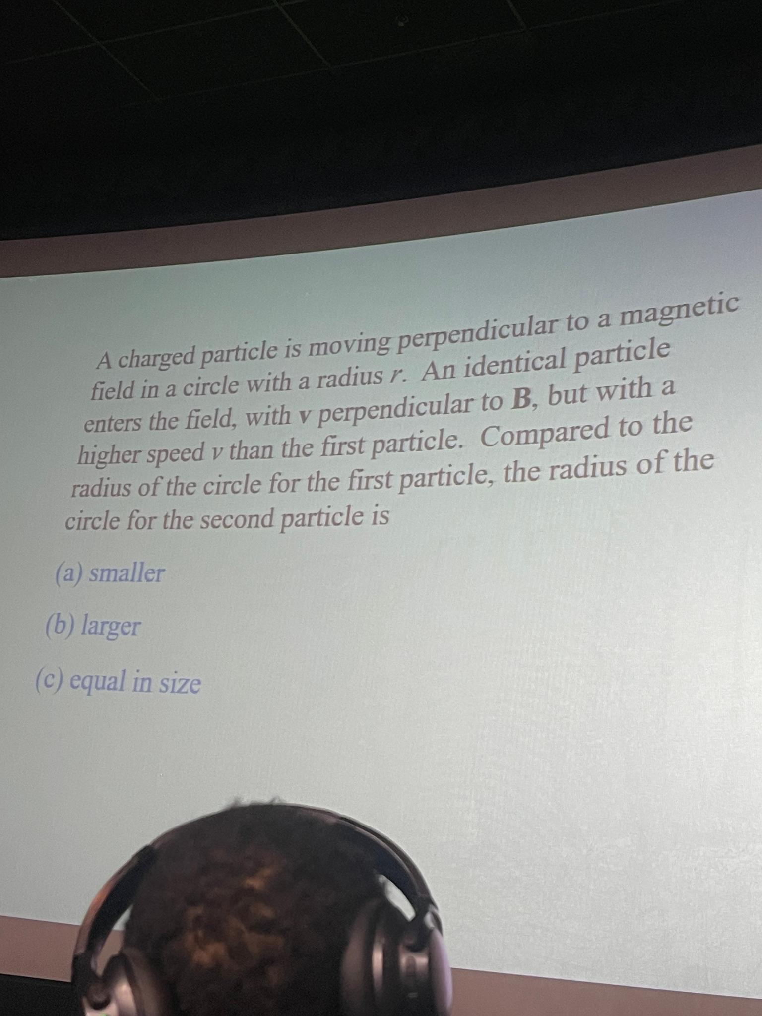 Solved A charged particle is moving perpendicular to a | Chegg.com