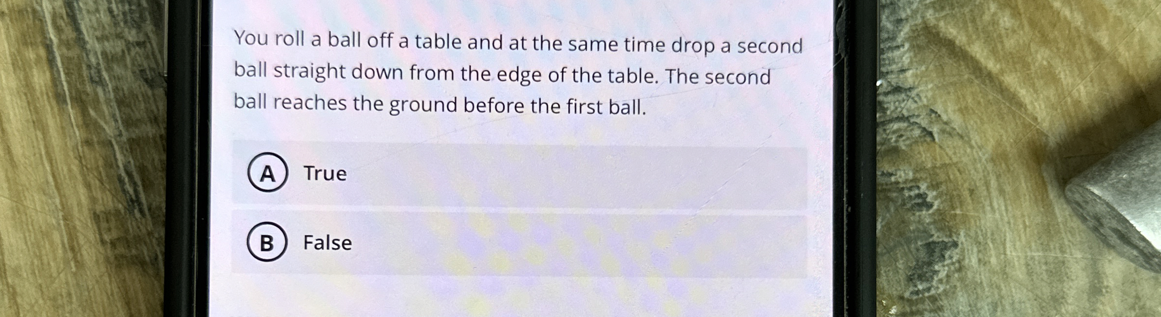 Solved You roll a ball off a table and at the same time drop | Chegg.com