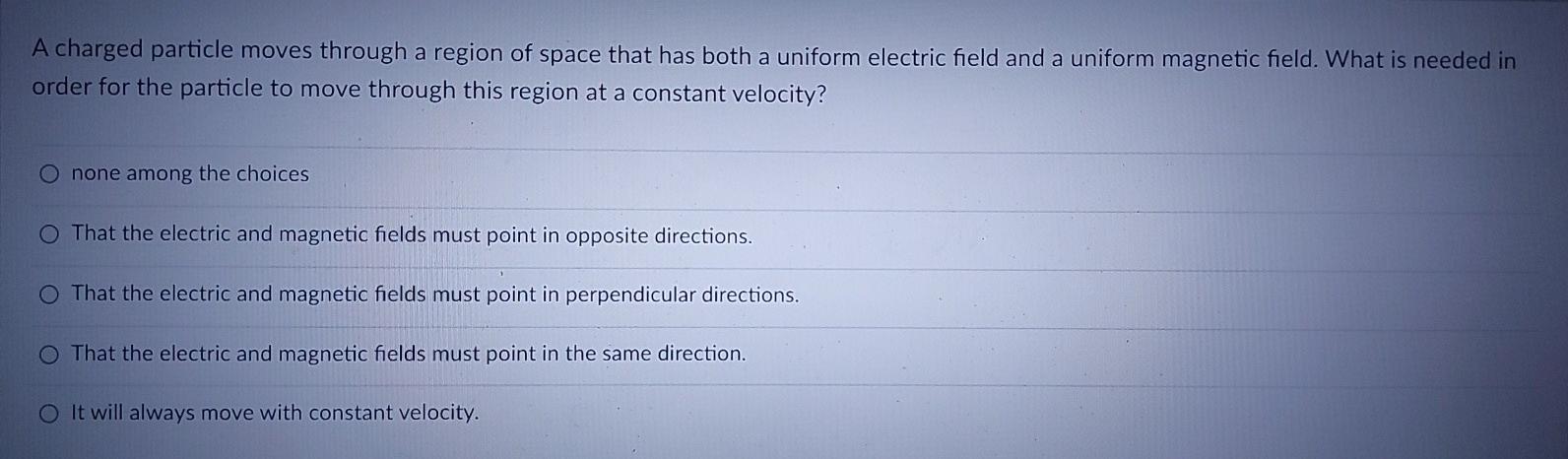 Solved A charged particle moves through a region of space | Chegg.com