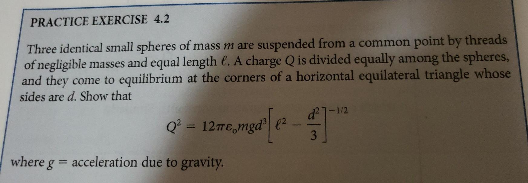 Solved PRACTICE EXERCISE 4.2 Three identical small spheres | Chegg.com