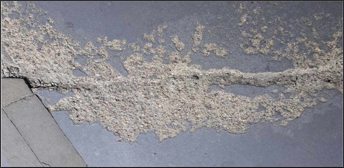 Solved The photograph below shows a concrete sidewalk at | Chegg.com