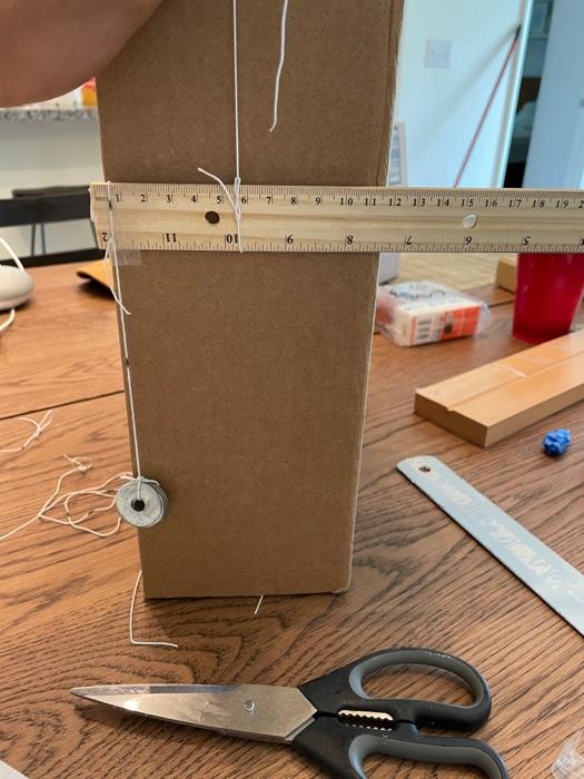 Solved 4 washer string on the ruler at 0.50cm position of | Chegg.com