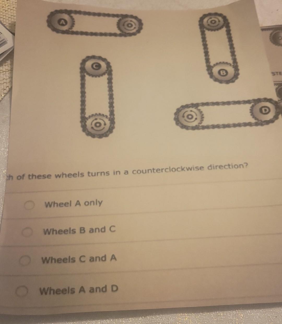 Solved Wh of these wheels turns in a counterclockwise | Chegg.com
